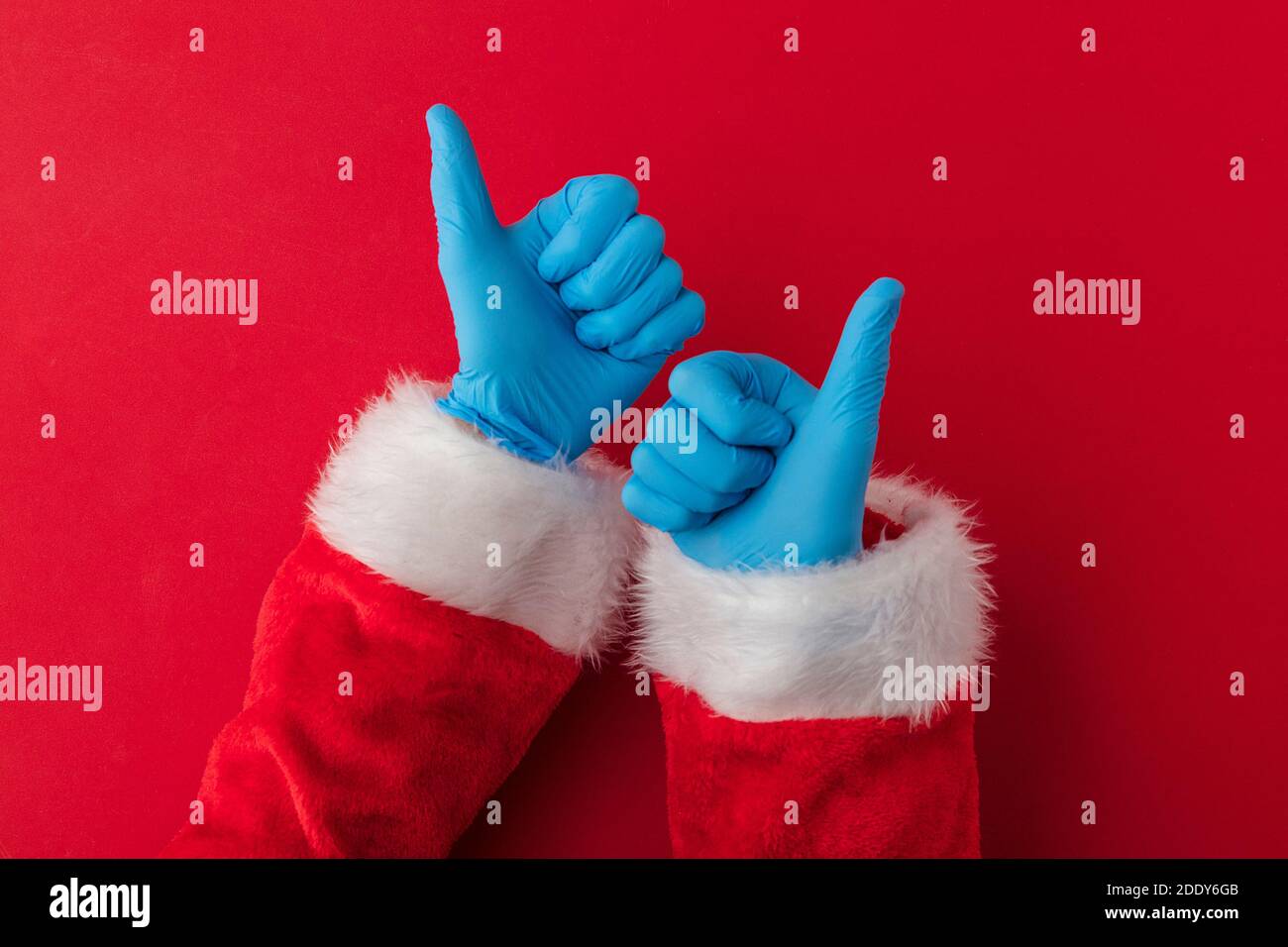 Santa hands wearing blue PPE protective gloves making thumbs up sign ...