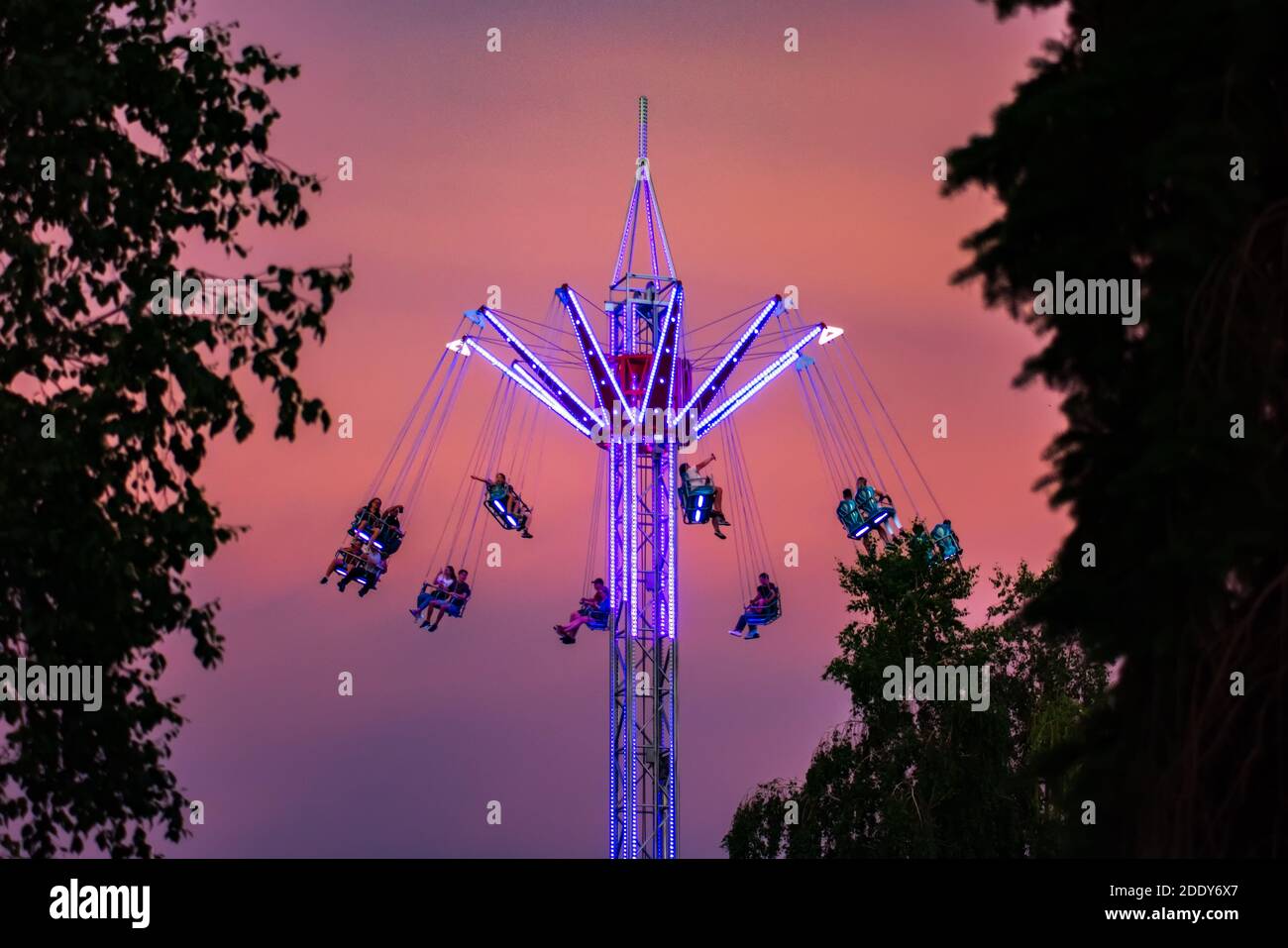 The attraction spinning carousel on a high tower Stock Photo - Alamy