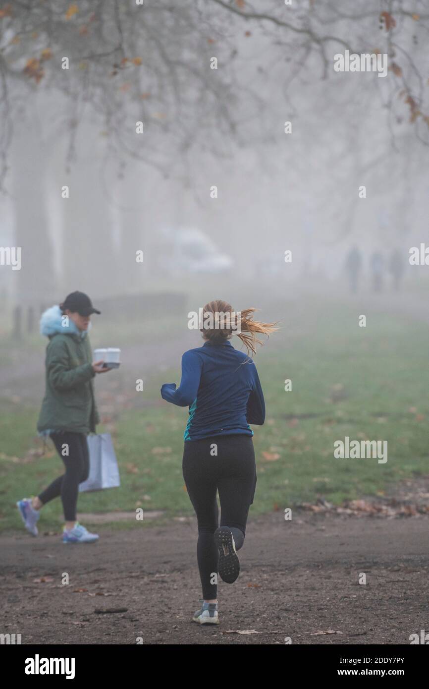 London, UK. 27th Nov, 2020. On a misty morning, Clapham Common is busy ...