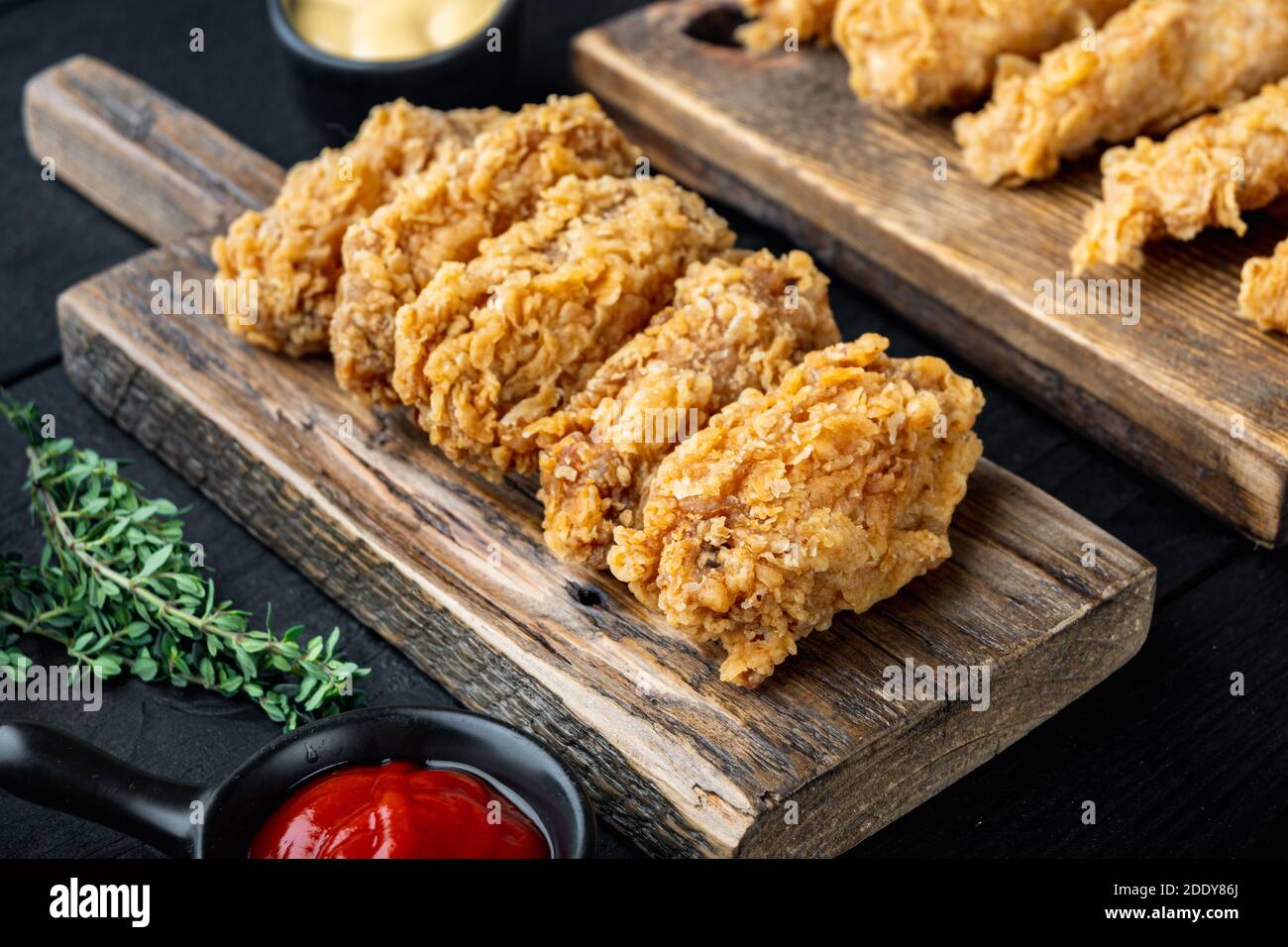 Fried chicken wings parts on black wooden background Stock Photo - Alamy