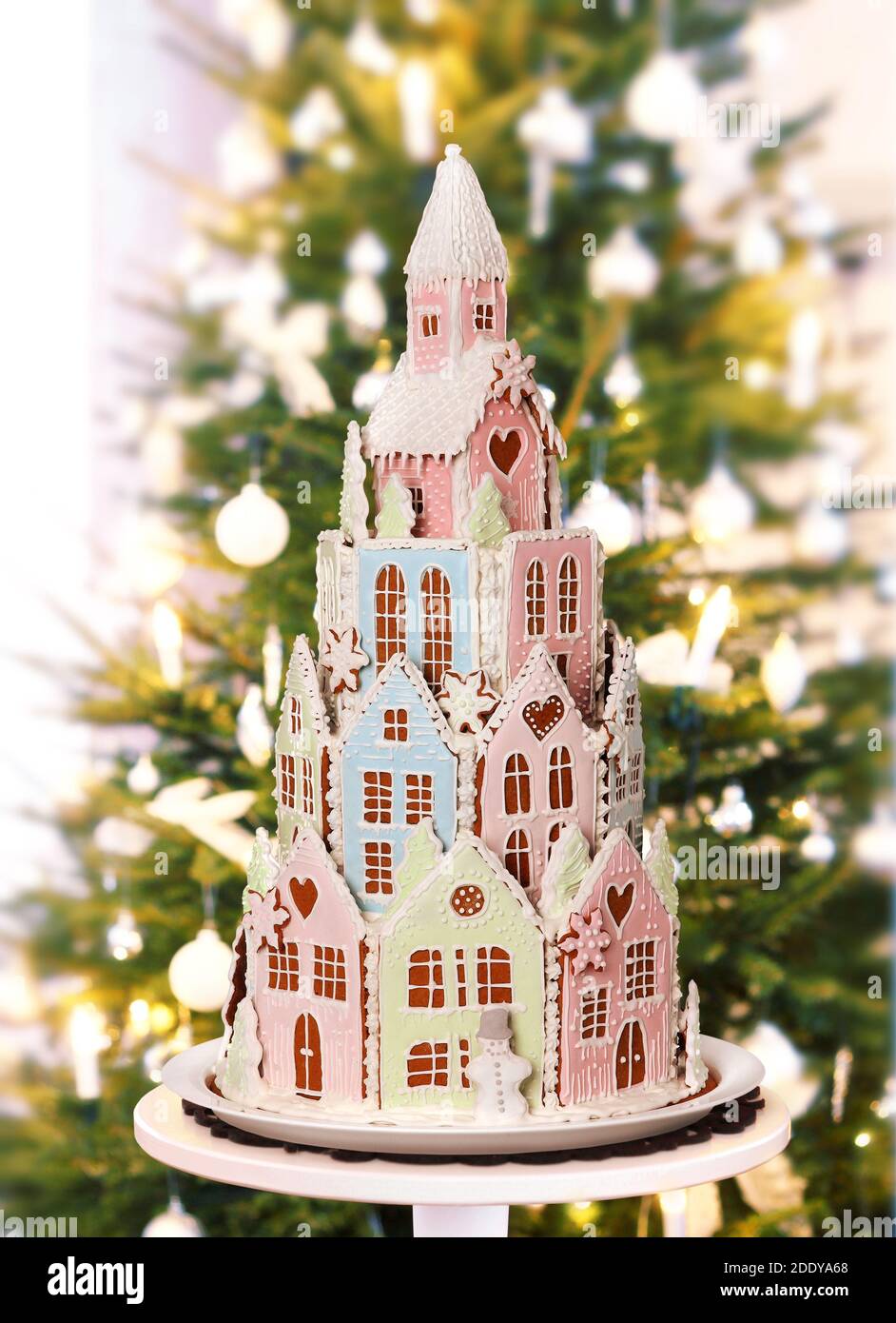 Gingerbread castle with real fir Christmas tree on home living room ...