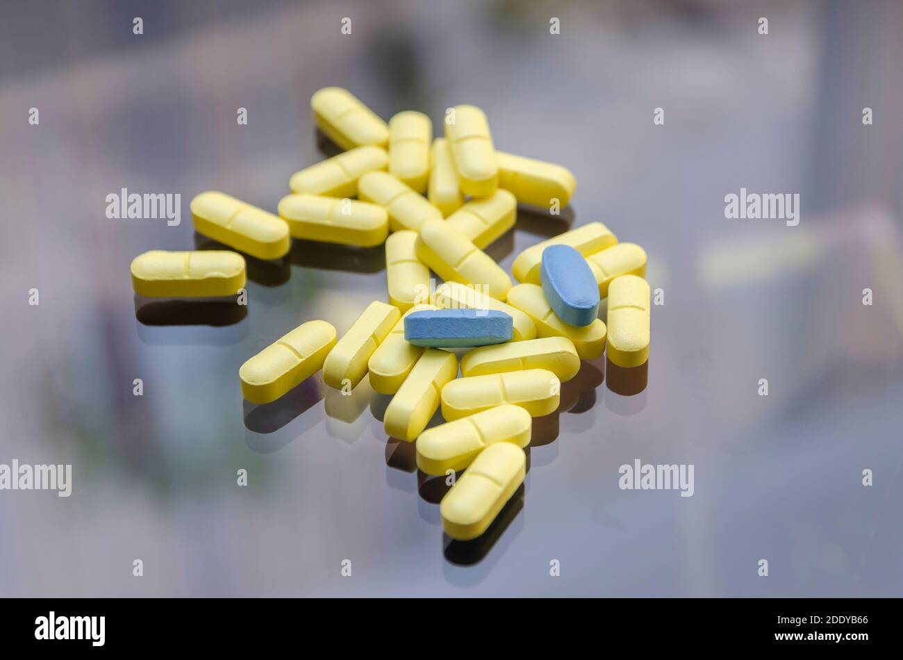 yellow pharmaceutical medicine pills, and two blue pills Stock Photo ...