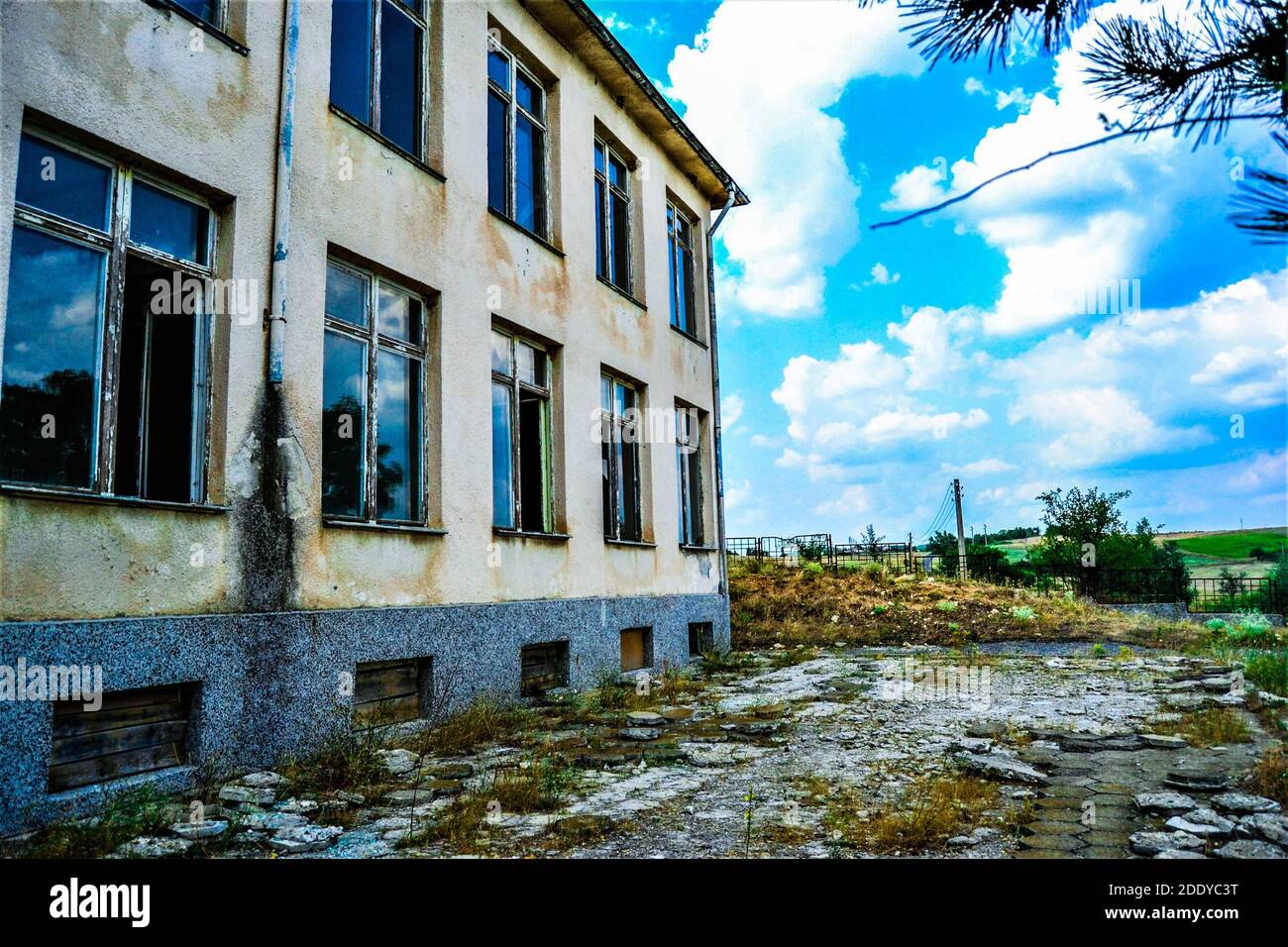 Old and brownfield school in bulgarian village. Blue sky background ...