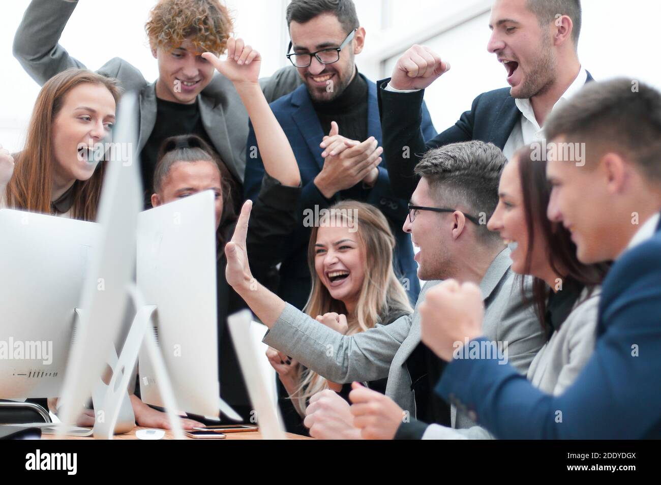 happy business team cheering near the desktop Stock Photo - Alamy