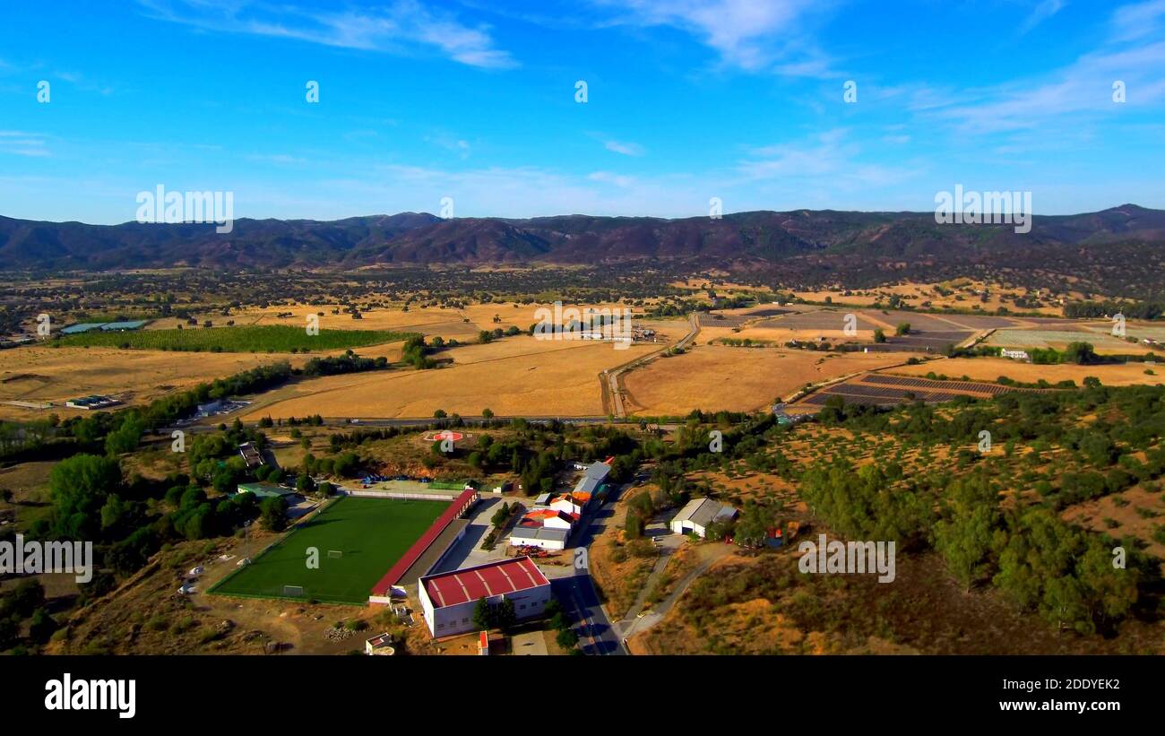 An aerial view of an agricultural cultivated area with rural buildings ...