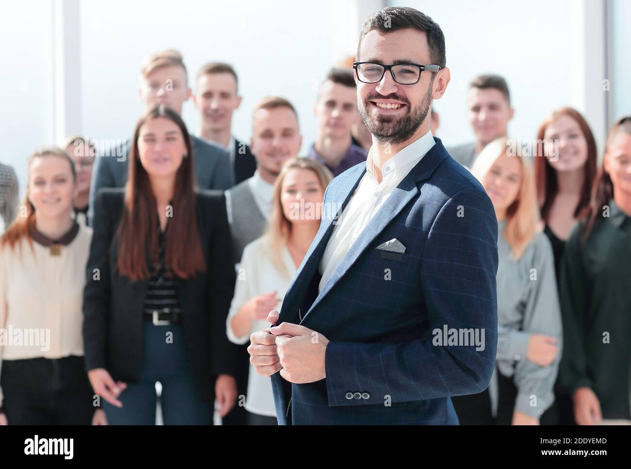 Manager and a group of diverse employees standing in the new office ...