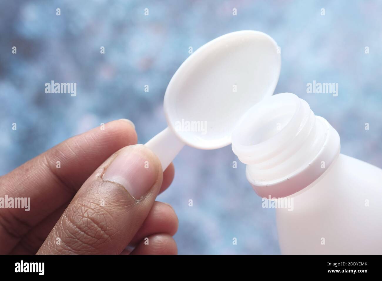 pouring liquid medicine onto a spoon top view Stock Photo - Alamy