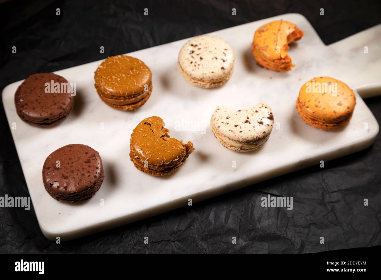 Vegan macarons on a marble platter. The French-style macaroons are made ...