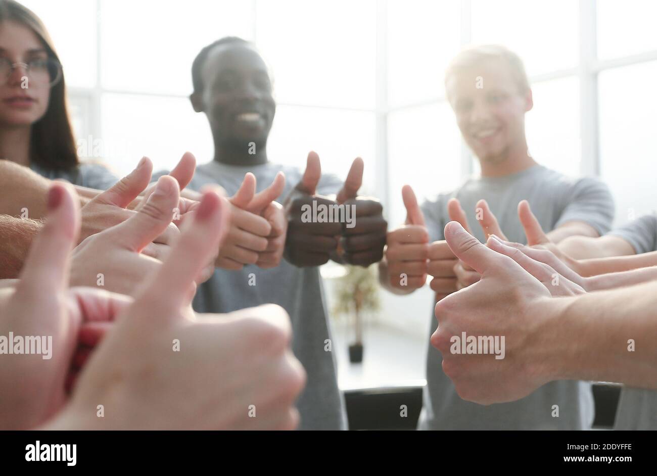 close up. group of young people showing thumbs up Stock Photo - Alamy