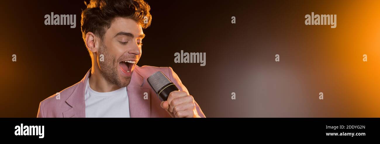Man singing while holding a microphone hi-res stock photography and ...