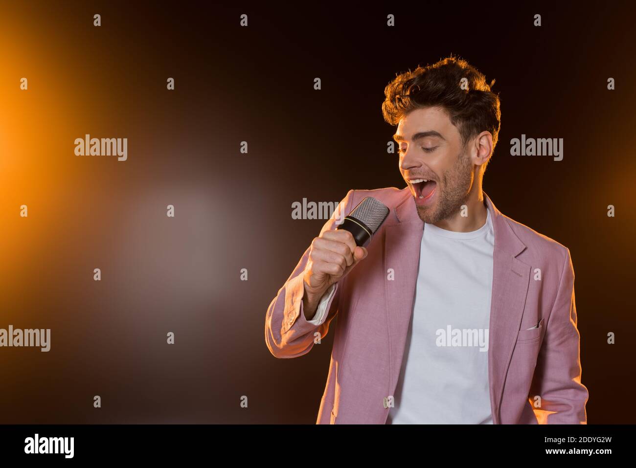 Man singing while holding a microphone hi-res stock photography and ...