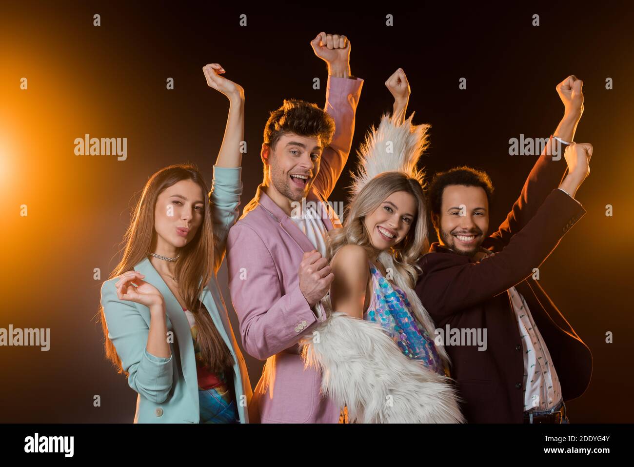 group of excited multicultural friends rejoicing on black Stock Photo ...