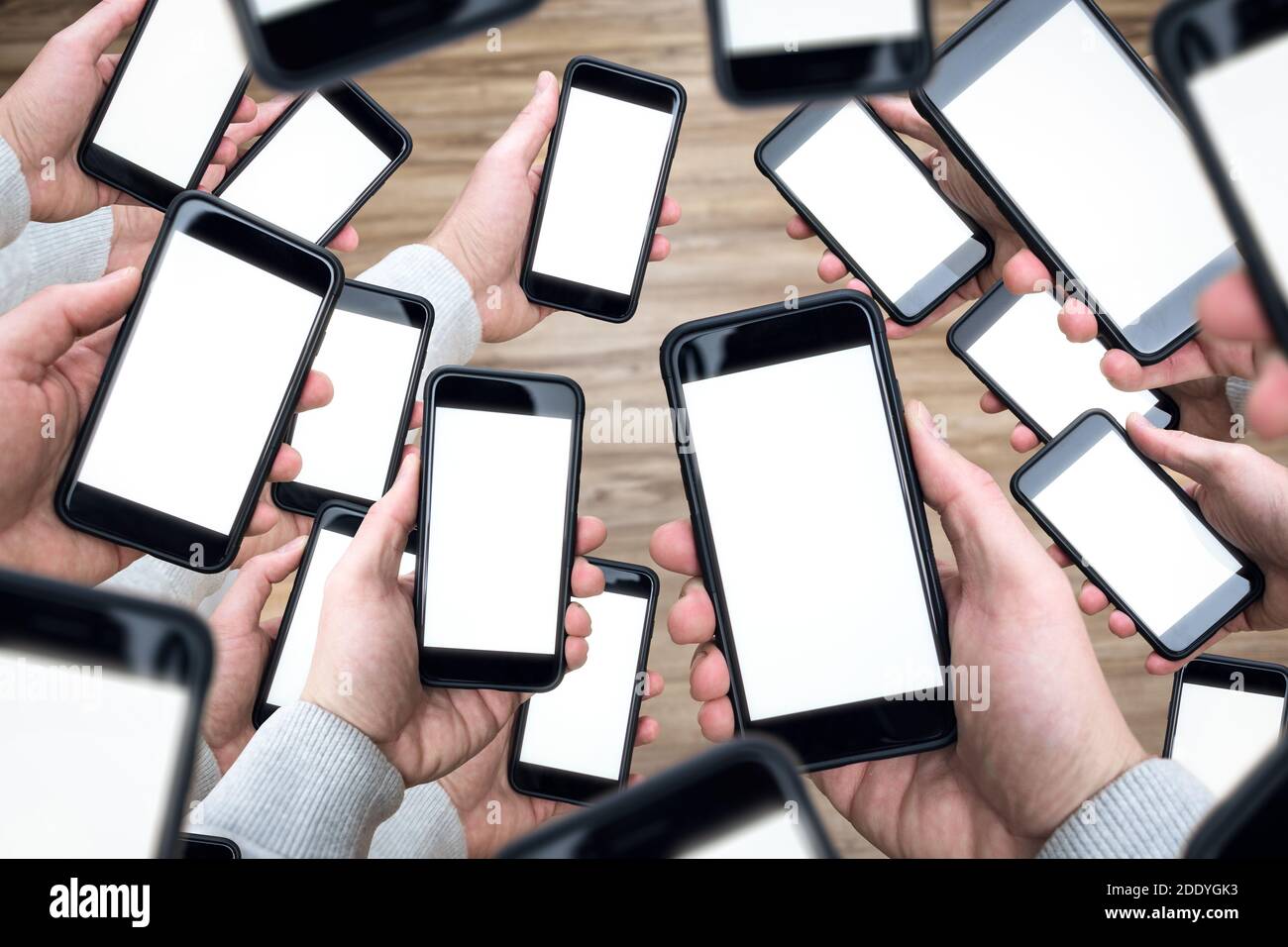 Many smartphones in many hands Stock Photo - Alamy