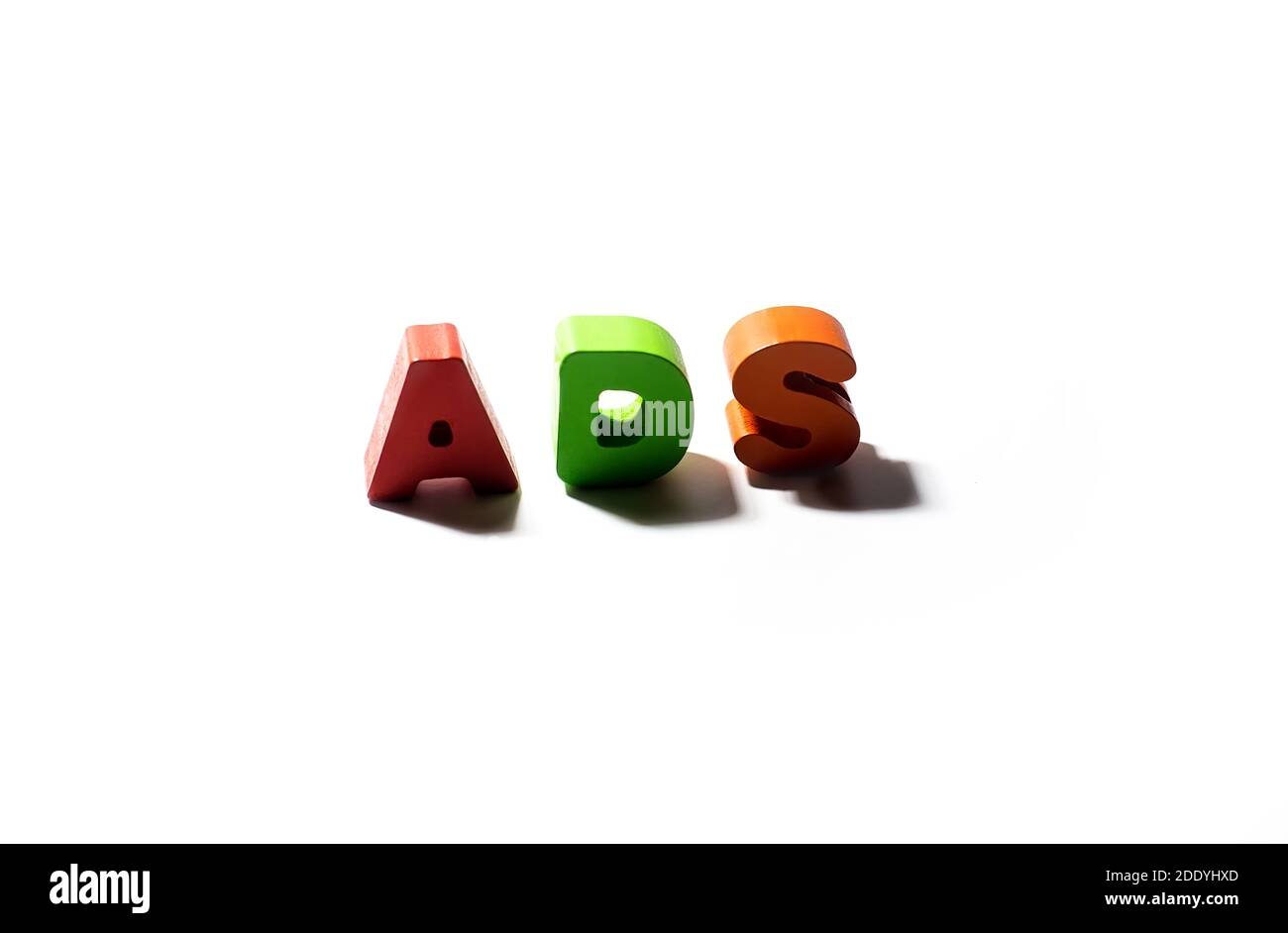 Ads word text spelling by wooden colorful carved letters standing at ...