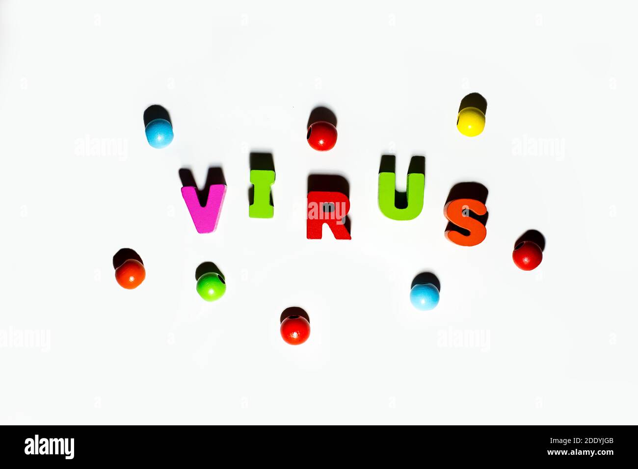 Word Virus with beads spread from colorful wooden letters at white ...