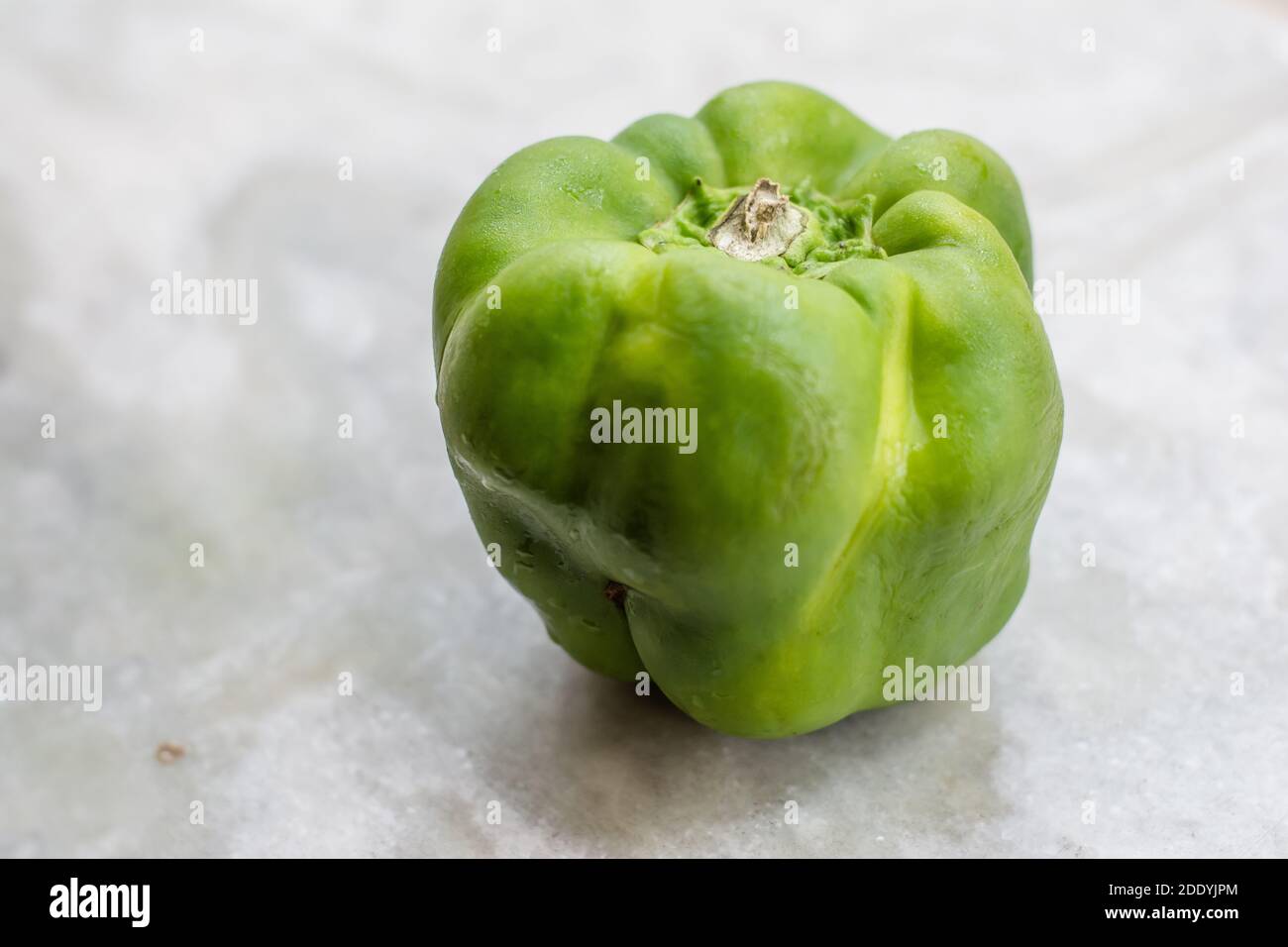Fresh green capsicum or bell pepper isolated on a white background ...