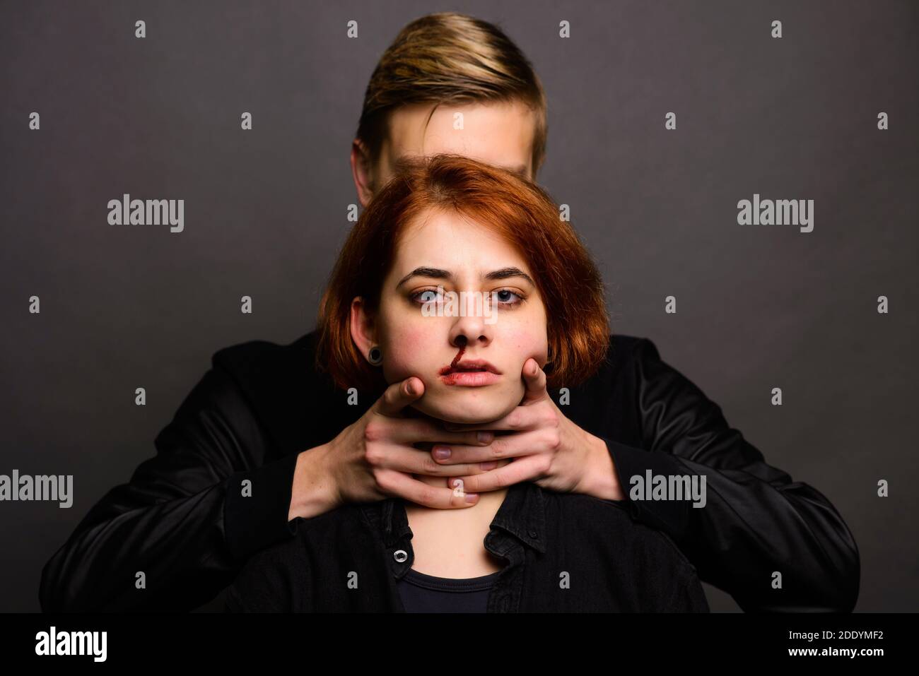 Desparate female with aggressive man in studio, domestic violence ...