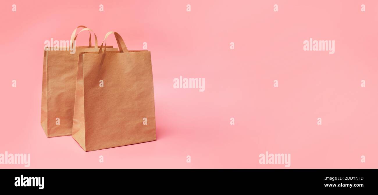 two paper craft packages, on a pink background, banner, copy space ...