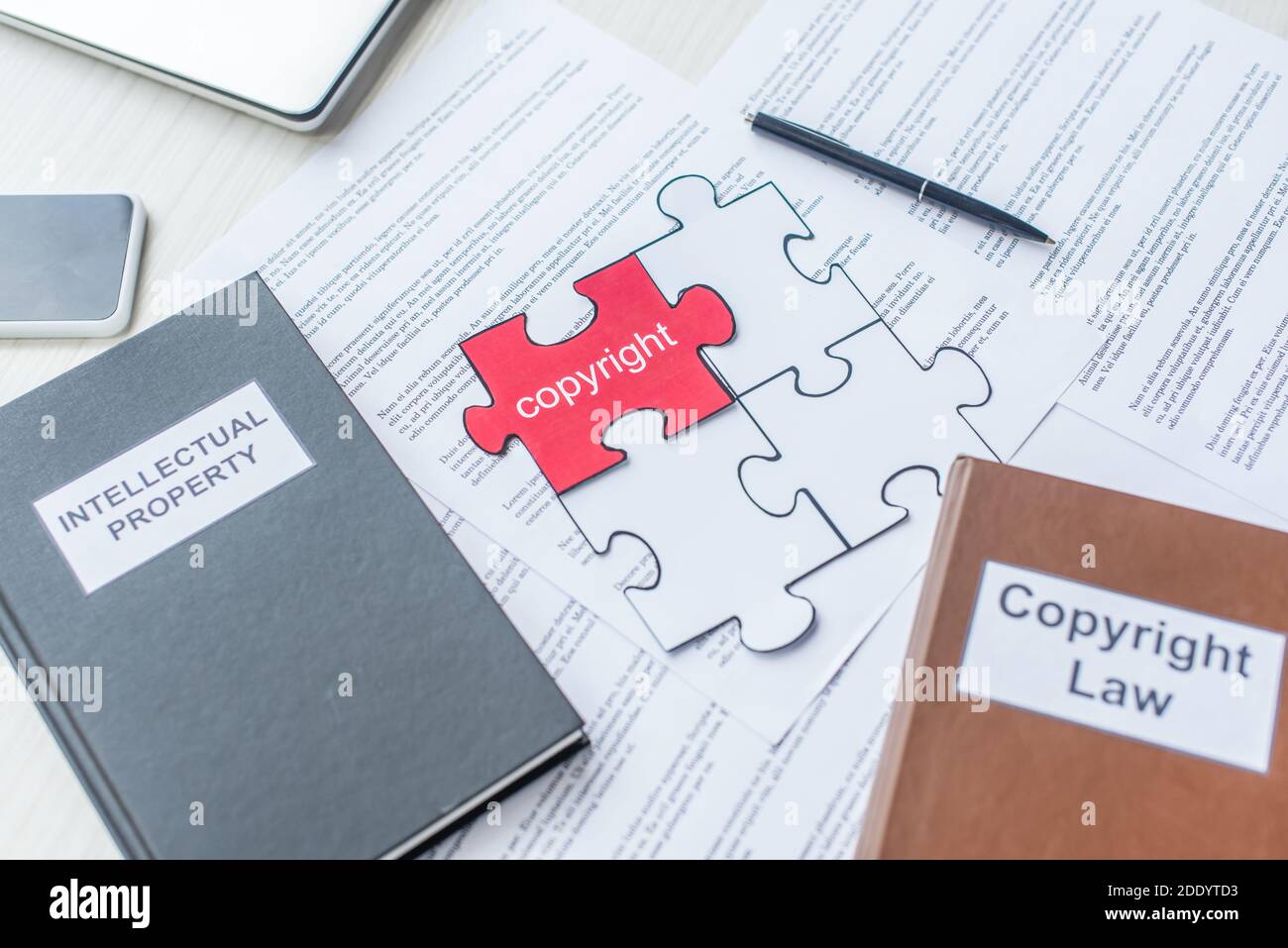 Jigsaw puzzles with copyright lettering on workplace with paperwork and ...