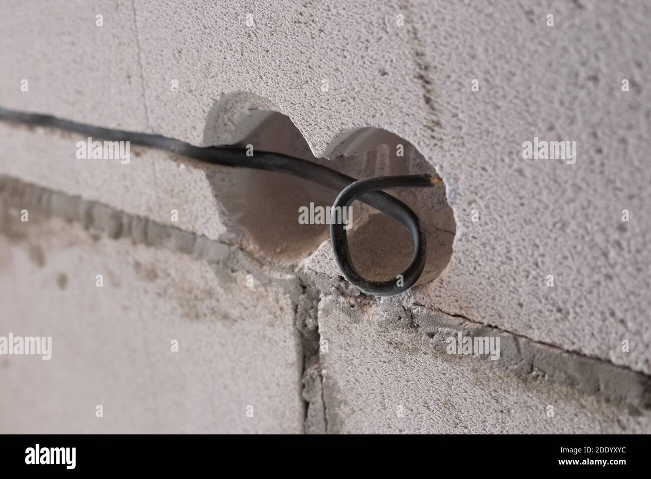 socket with a wire in aerated concrete for an electrical outlet. House ...