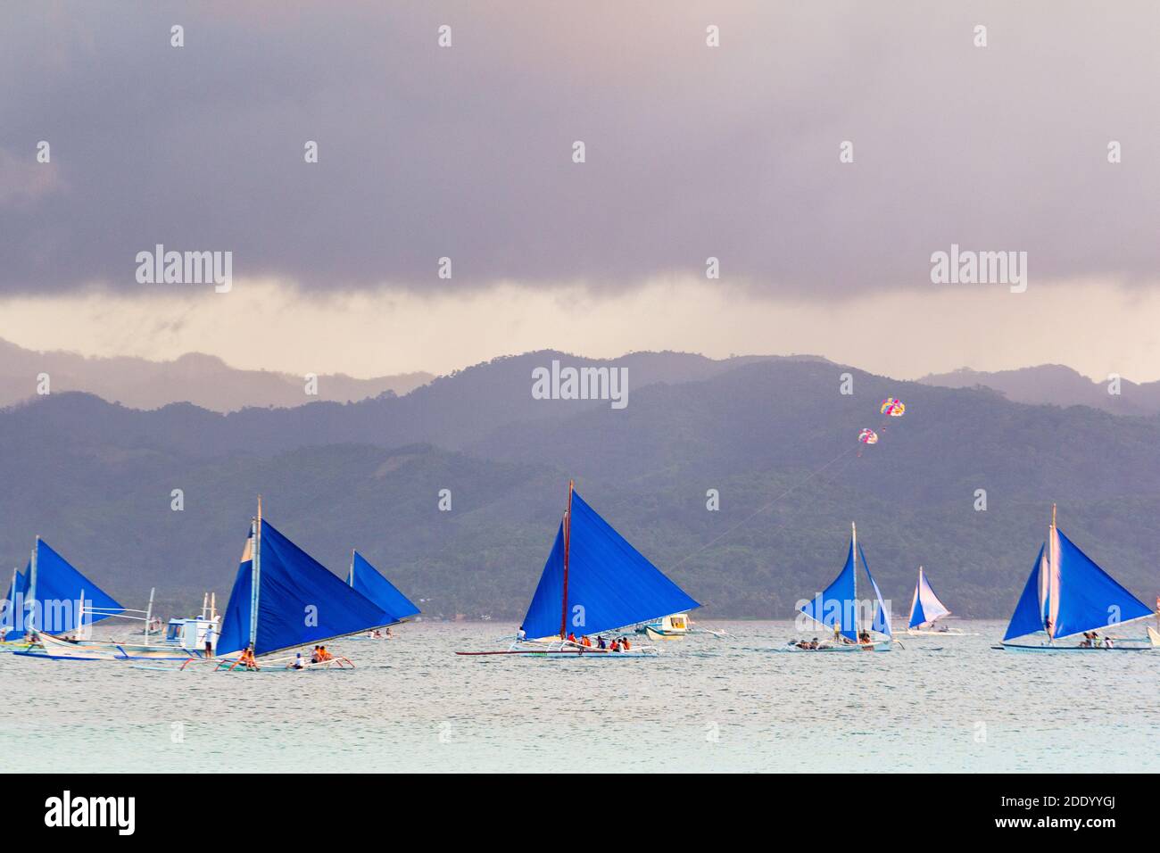 Local sailboats called paraw during afternoon in Boracay, Philippines ...