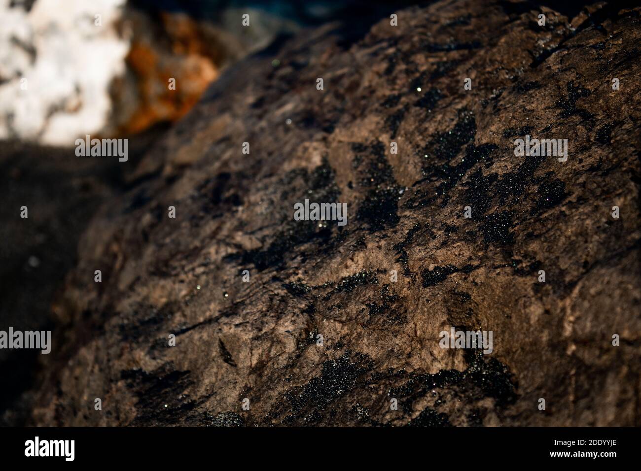 Black sand on volcanic rock Stock Photo - Alamy