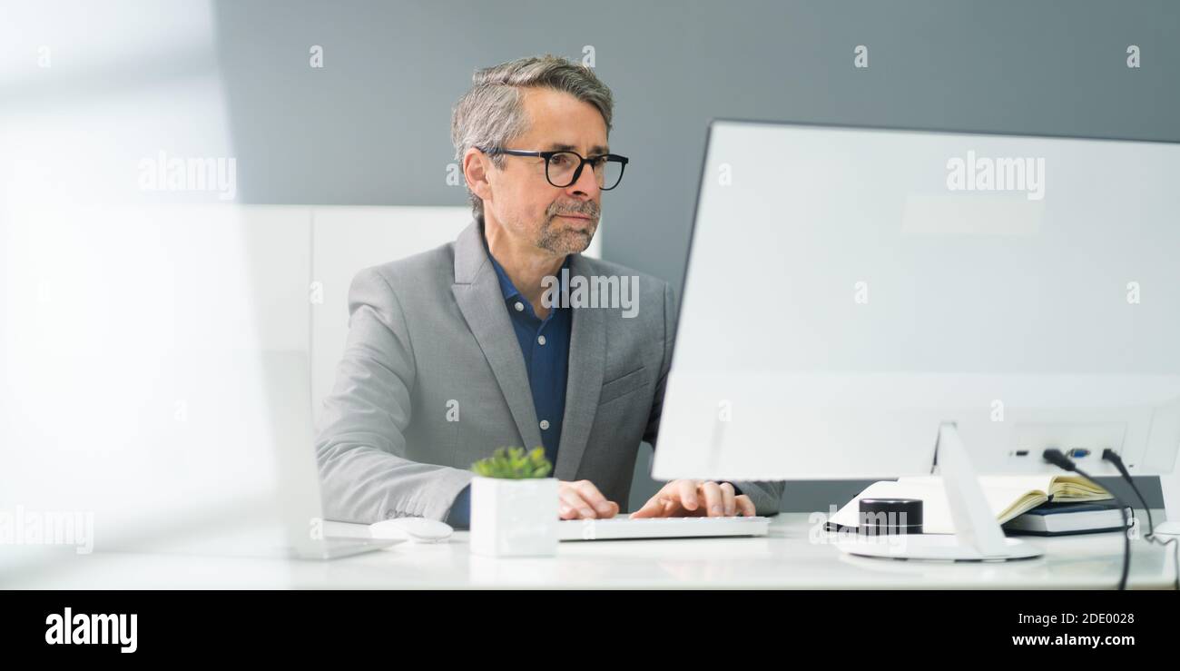 Happy Professional Man Employee Using Computer For Work Stock Photo - Alamy