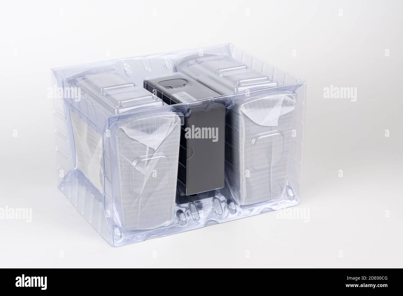 Two computer speakers in transparent plastic bag on white background ...