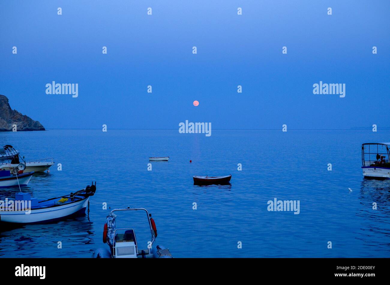 Full moon rises from the sea Stock Photo - Alamy