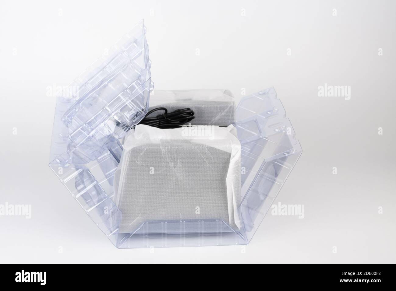 Two computer speakers in transparent plastic bag on white background ...