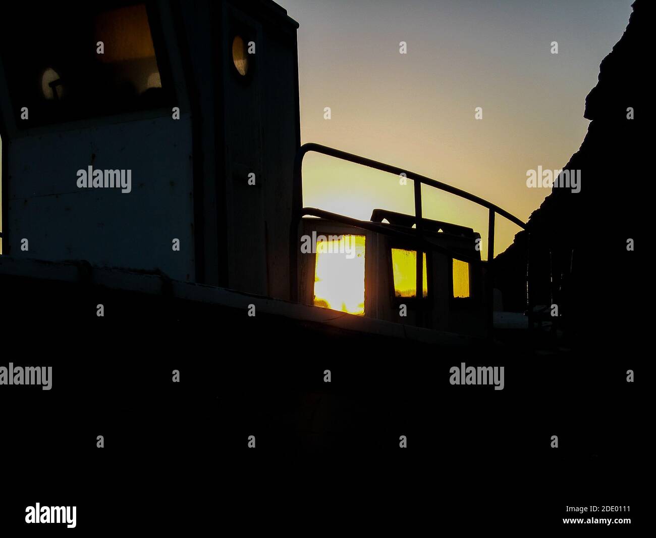 Sunset behind the fishing boat Stock Photo - Alamy