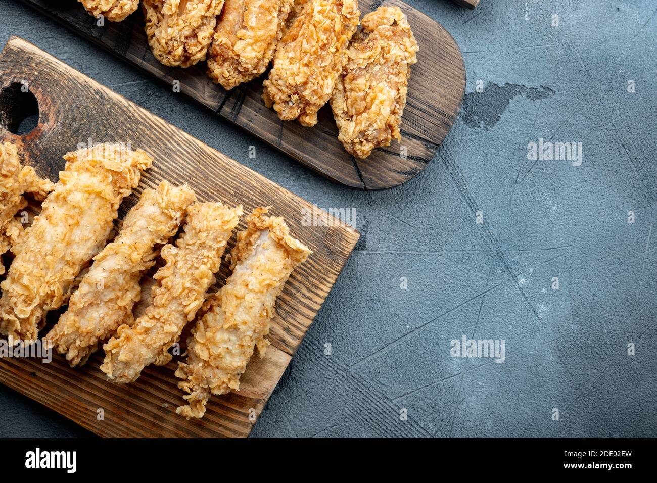 Crispy kentucky fried chicken cuts on grey background, top view, with ...