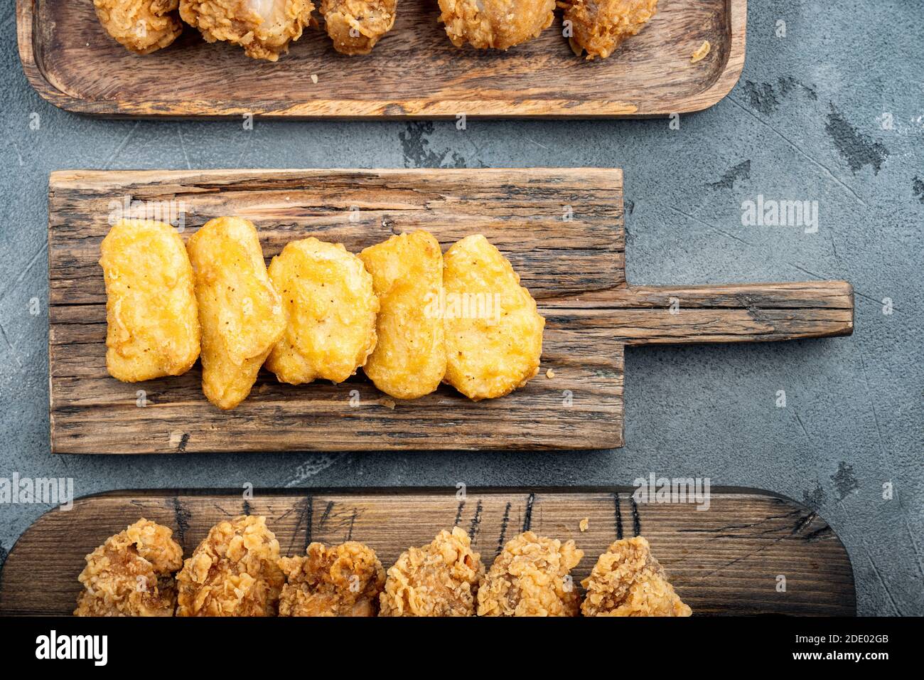 Fried crispy chicken nuggets meat on grey background, top view Stock ...