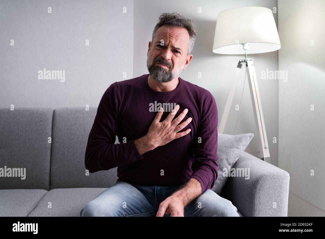 Elder Man With Chest Pain. Sick Elderly At Couch Stock Photo - Alamy