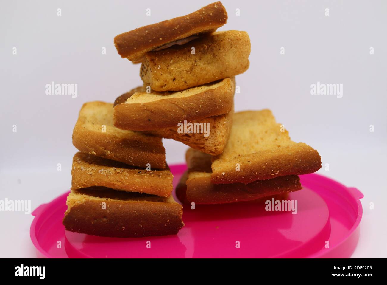 stack of dry toast on Plastics plate. Close Up Pile of toasted bread ...
