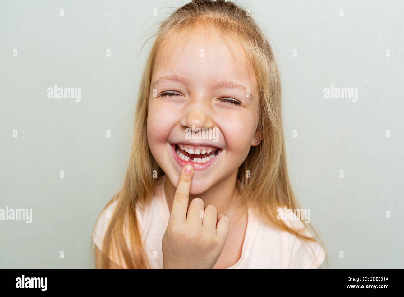 Kid showing the first milk tooth. Change teeth concept. Cute little ...