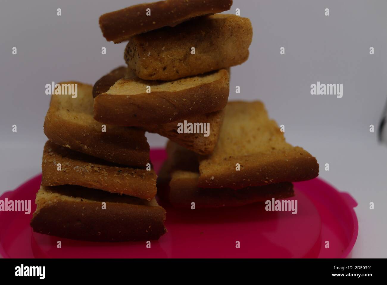 stack of dry toast on Plastics plate. Close Up Pile of toasted bread ...