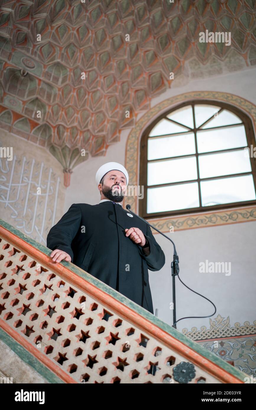 Emam in mosque with Arabic verses from Kuran on the wall Stock Photo ...