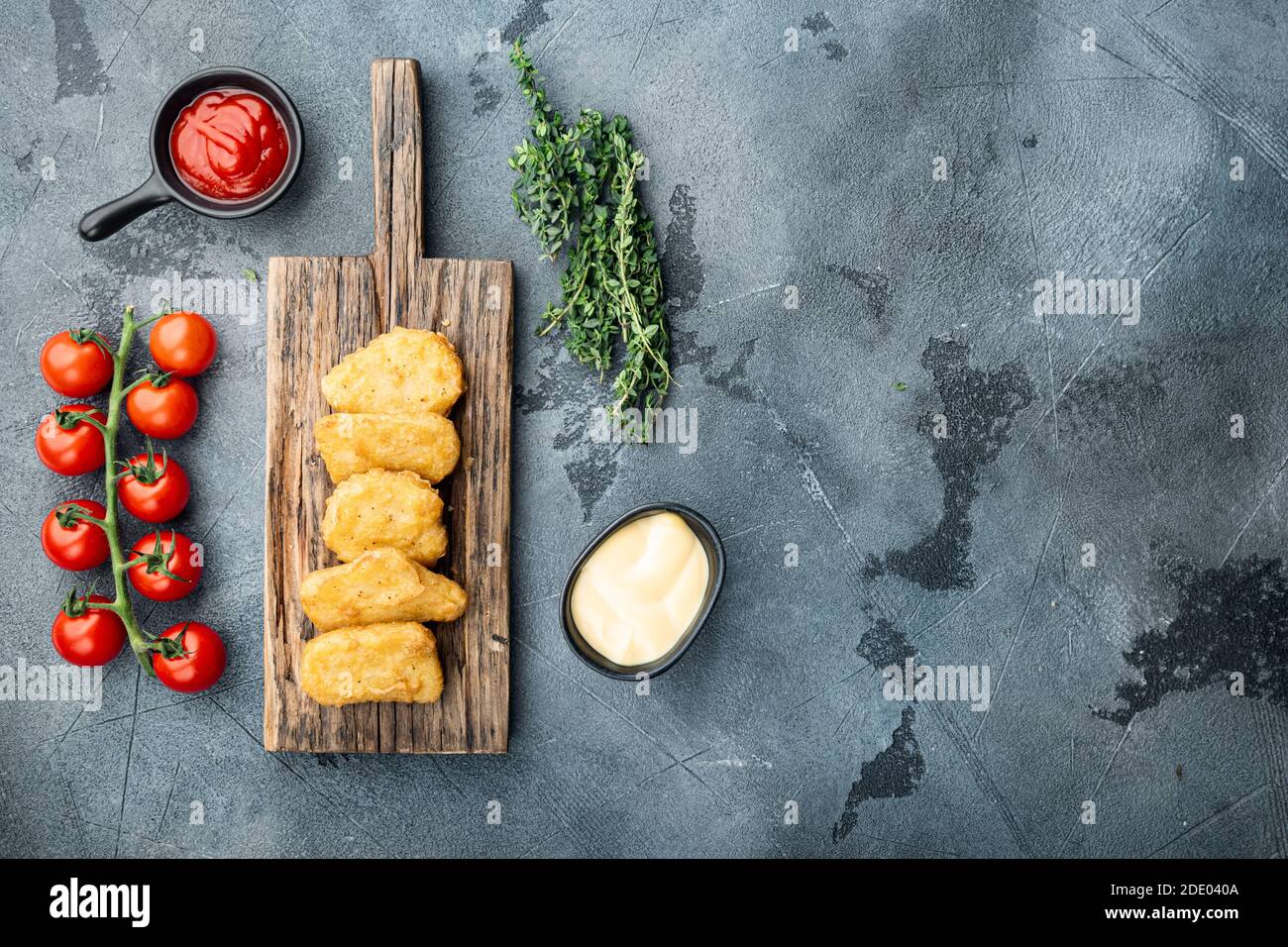 Fried crispy chicken nuggets meat on grey background, top view Stock ...