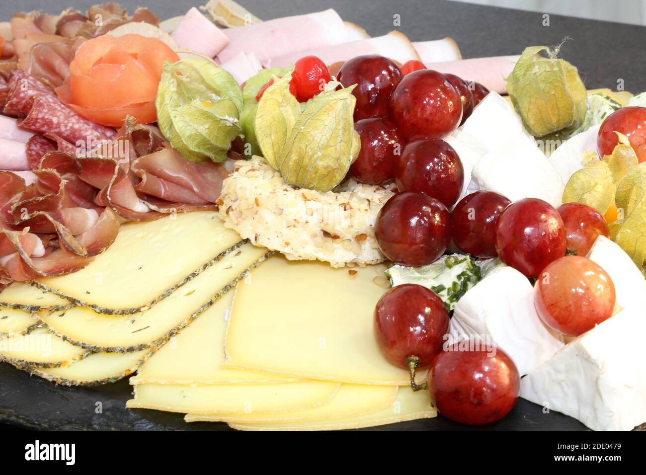 Catering: Cold plate with cheese, ham and grapes Stock Photo - Alamy