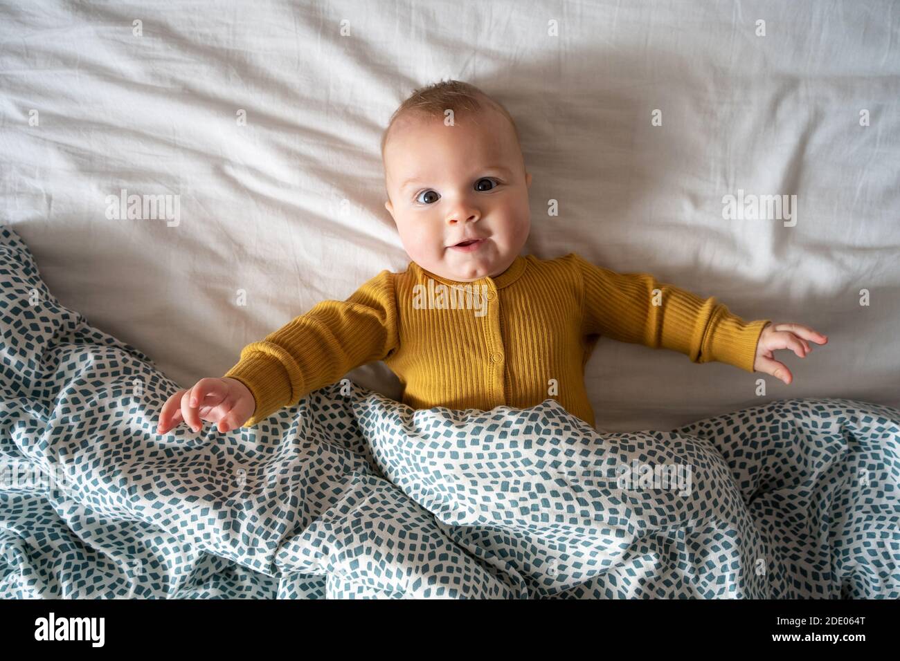 Five months baby boy. Adorable baby boy in sunny bedroom. Newborn child ...