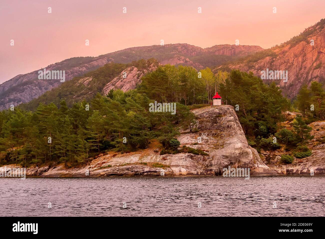 Norwegian landscape with fjord water, lighthouse and forest mountains ...