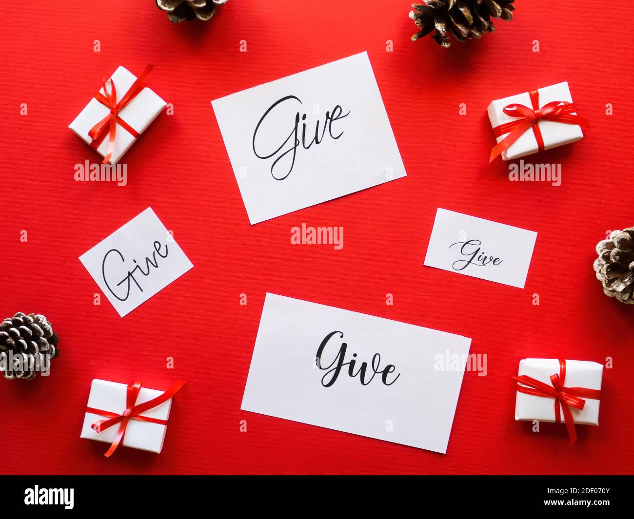 Multiple white gift boxes, notes with messages and fir cones. Red ...