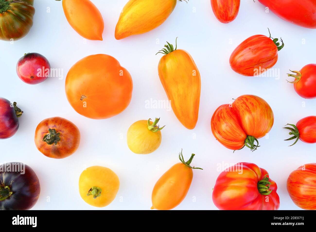 Colorful heirloom tomatoes background. Different varieties Stock Photo ...