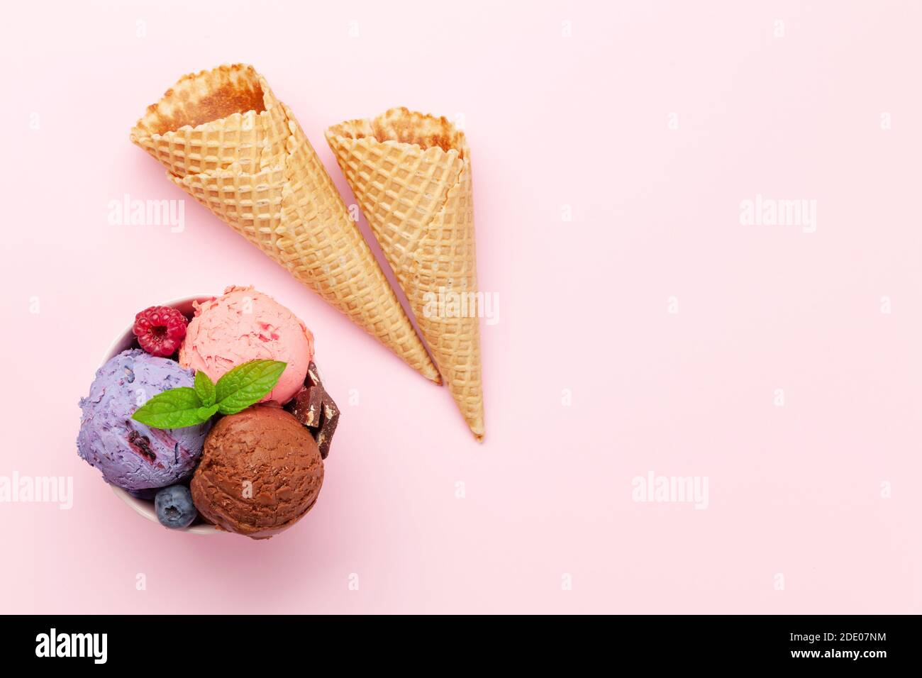 Berry, vanilla and chocolate ice cream sundae. Top view flat lay with ...