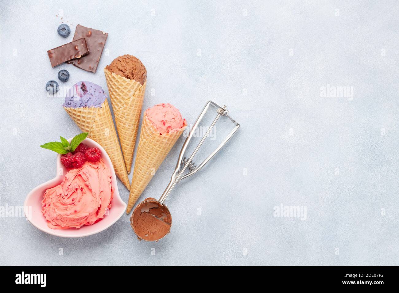 Berry, vanilla and chocolate ice cream sundae. Top view flat lay with ...