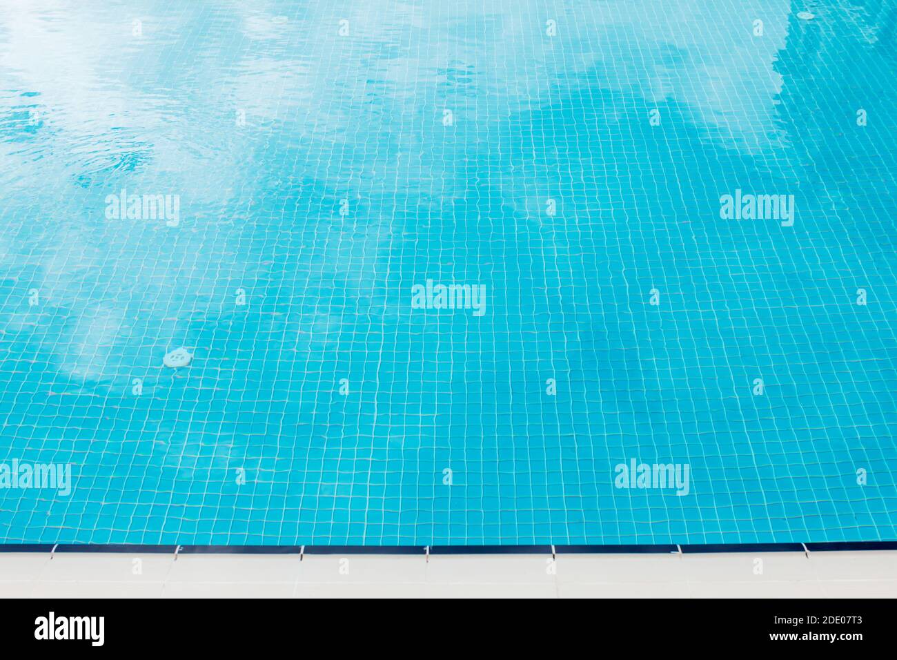 Sunny swimming pool in tropical resort. Summer vacation concept with ...