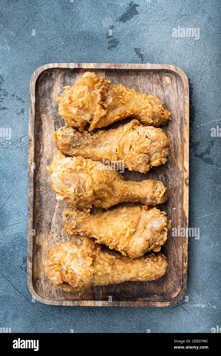 Chicken leg breaded on grey background, flat lay Stock Photo - Alamy