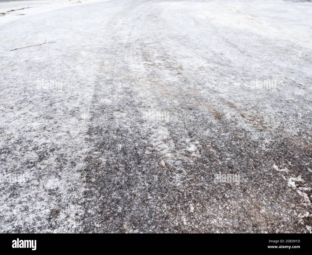 slippery ice-covered city road after freezing rain on cold autumn day ...