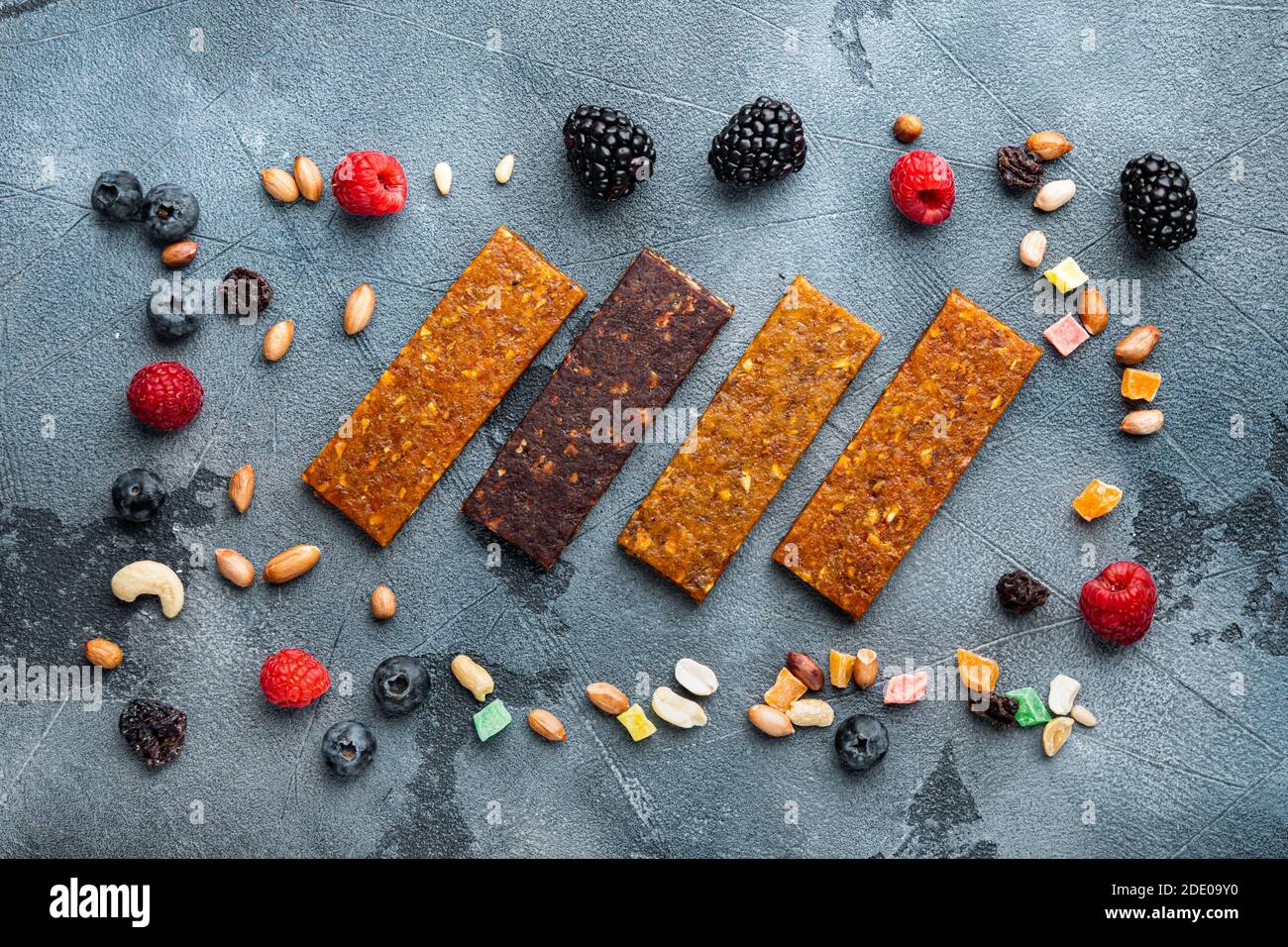 Dried fruits bars, flat lay, on grey background Stock Photo - Alamy